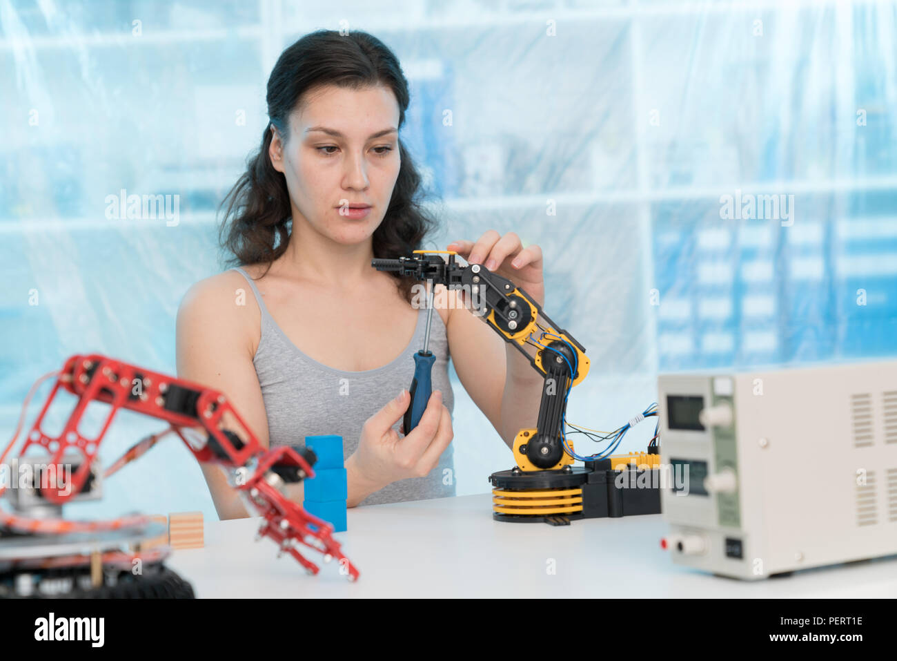 girl in a University laboratory is experimenting with a robot Stock ...