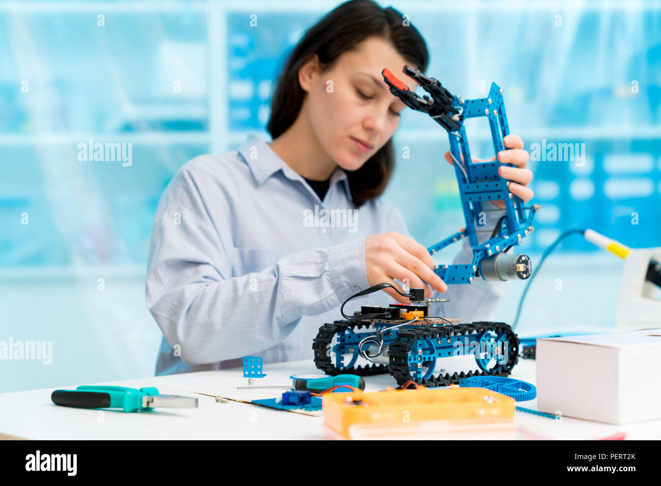 Student girl in electronics laboratory, experiment with microcontroller ...