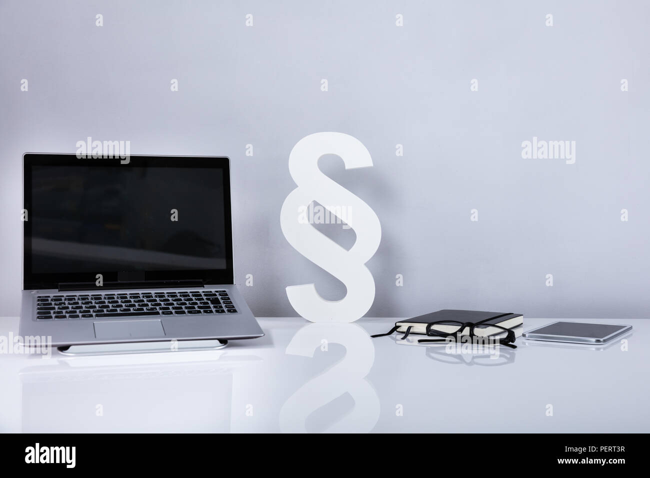 Laptop With Blank Screen And White Paragraph Symbol On Reflective Desk ...