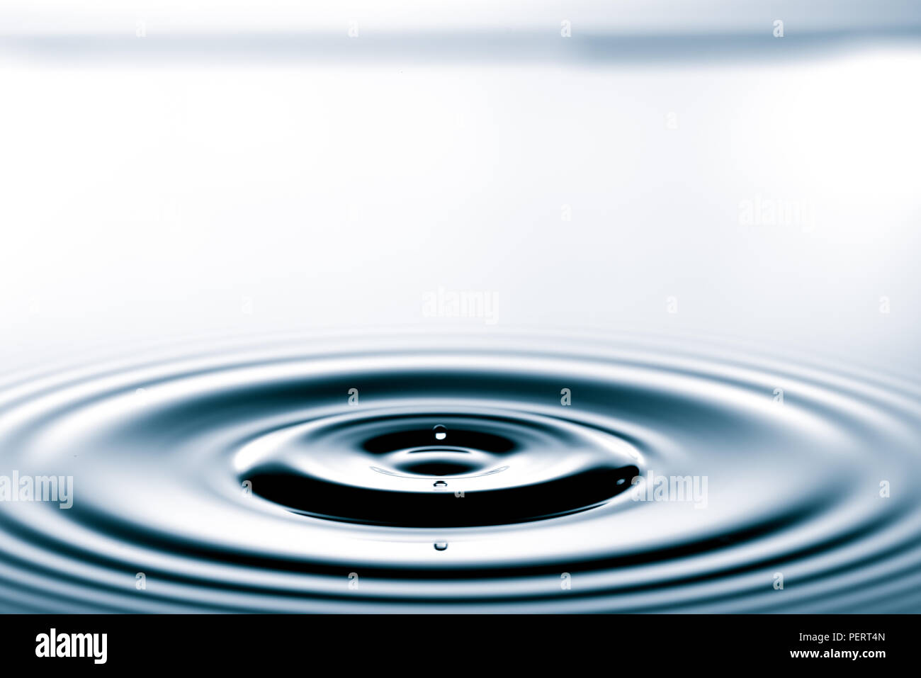 Splash of the falling drops of water Stock Photo - Alamy