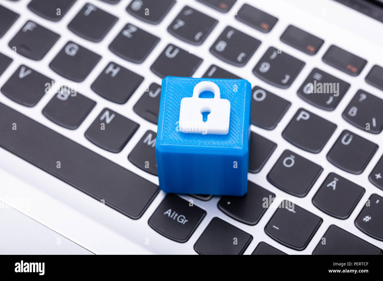 Blue Cubic Block With Lock Symbol On Laptop Keypad Stock Photo - Alamy
