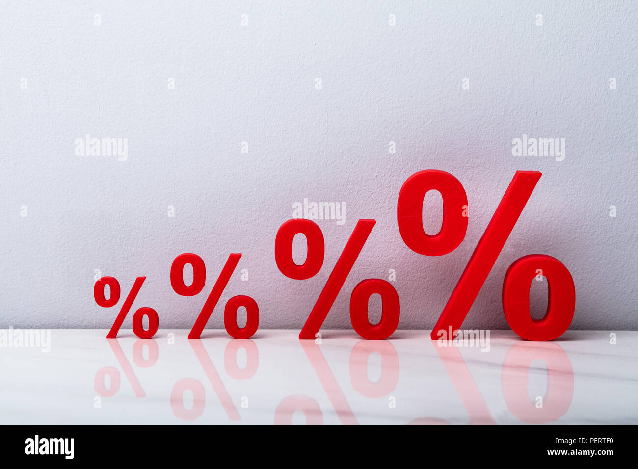 Increasing Size Of Red Percentage Symbols In A Row Stock Photo - Alamy