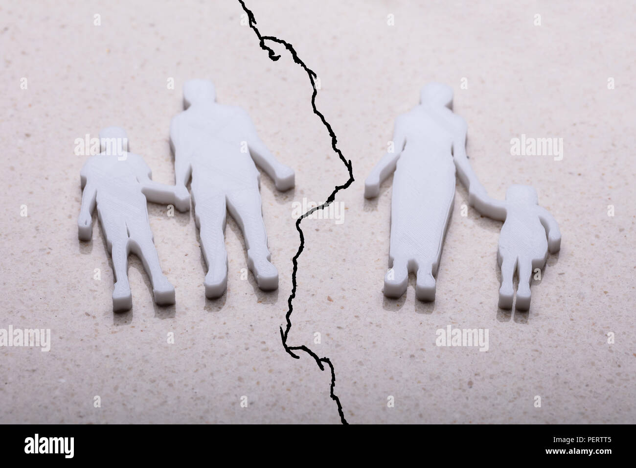 Separation Of Family Figures On Marble Background Stock Photo - Alamy