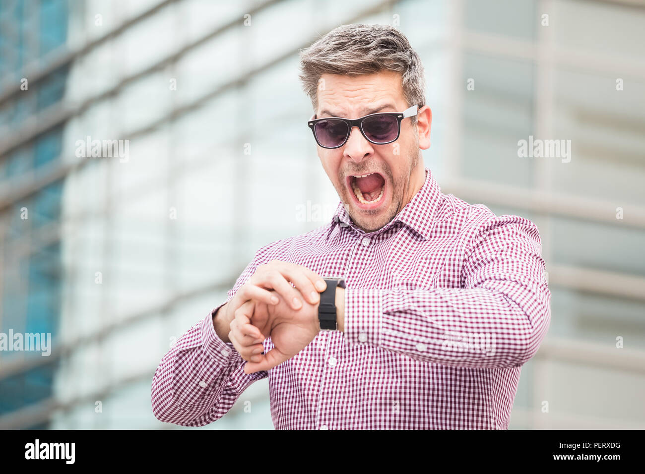 Stressed up office worker or businessman looking at his watch. Late for ...