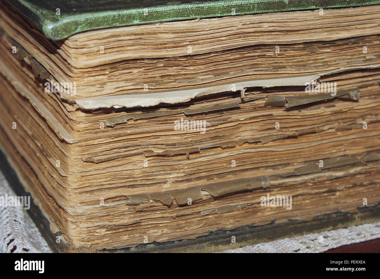 old closed green leather bound book lying on its side with only bottom ...