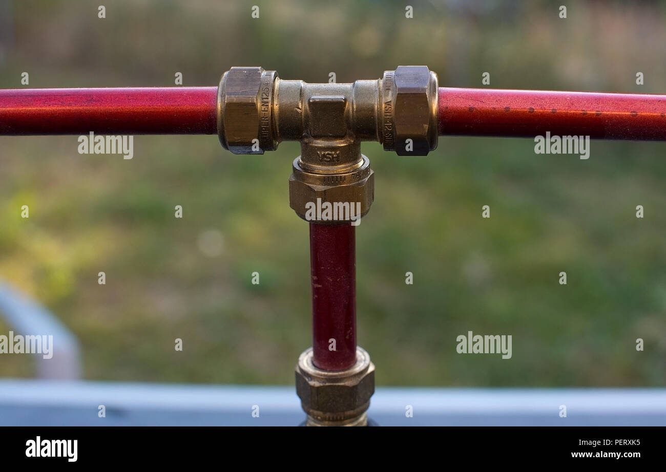 Metal plumbing water three way connector bolt outdoors Stock Photo - Alamy