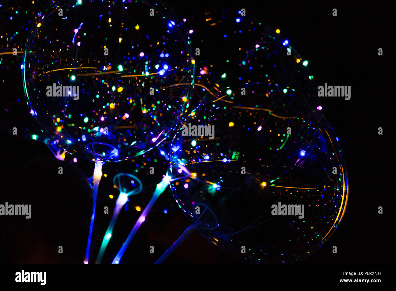 Colored lights on the balloons glow in the dark Stock Photo - Alamy