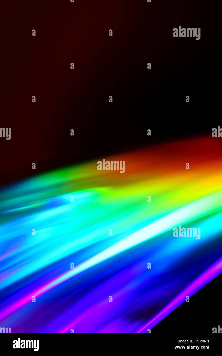 Beams of light refracting and creating a rainbow spectrum of colours ...