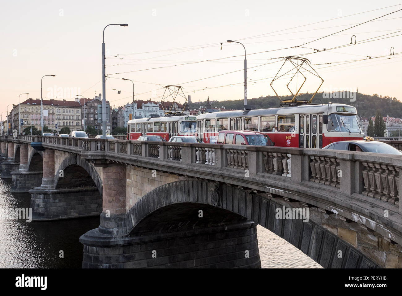 Cars and trams lined up on Palacky bridge on a summer evening in Prague ...