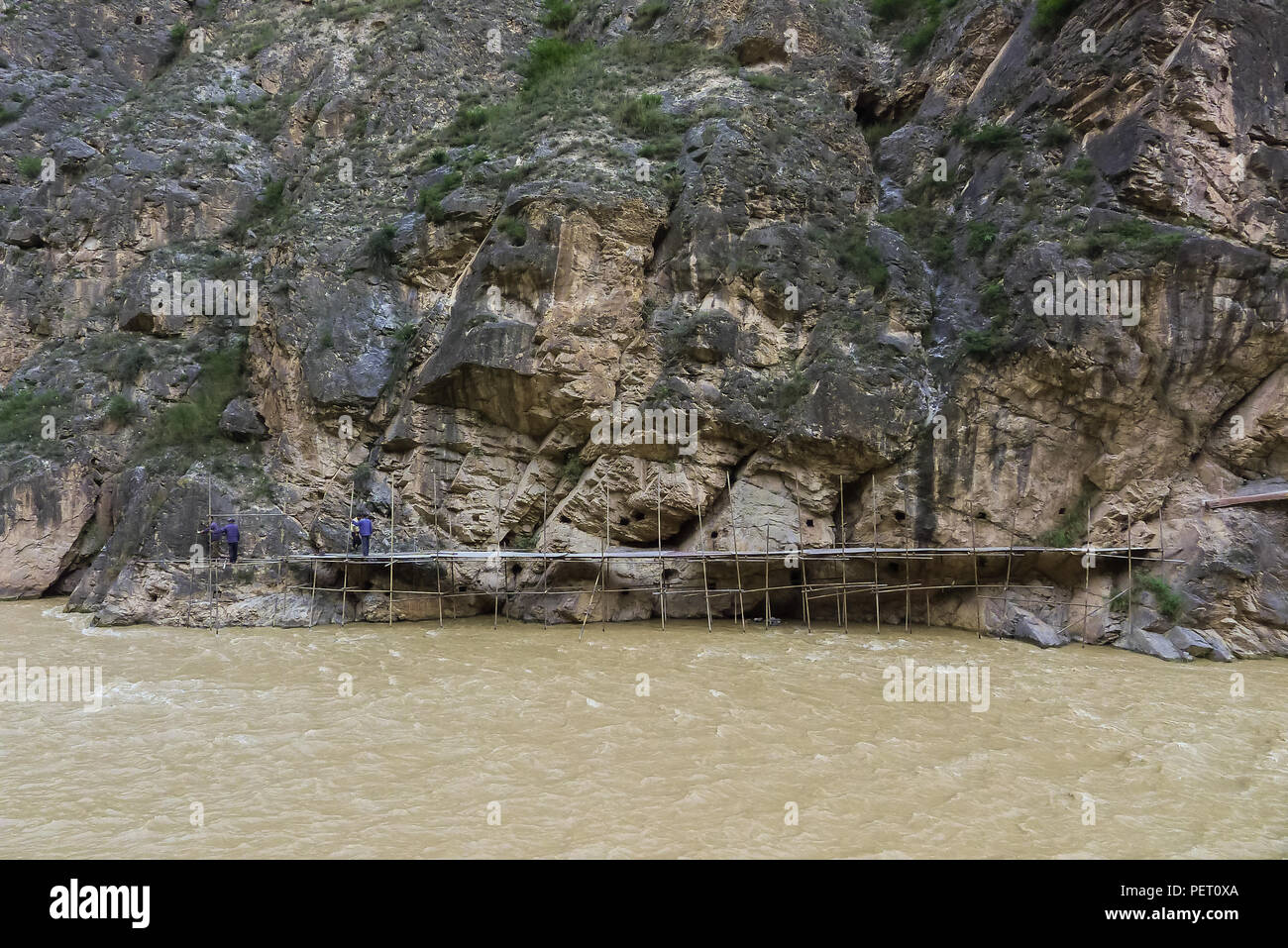 workers are working under a mountain Stock Photo - Alamy
