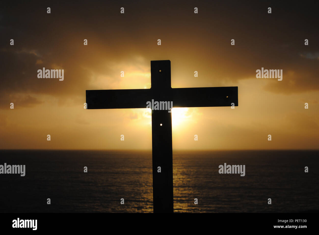 A beautiful photo in which the cross cover the light of the sun in a ...
