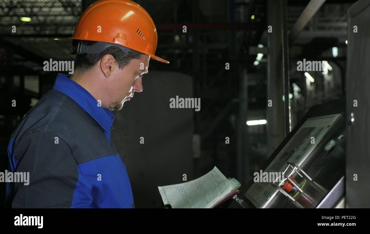 Operator monitors control panel of production line. Manufacture of ...