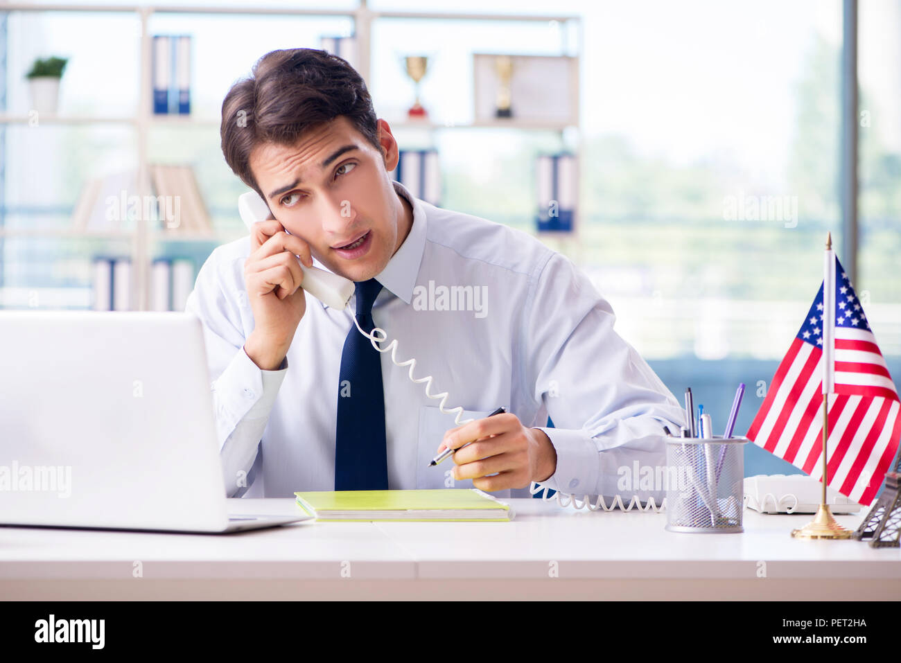 Sales agent working in travel agency Stock Photo - Alamy