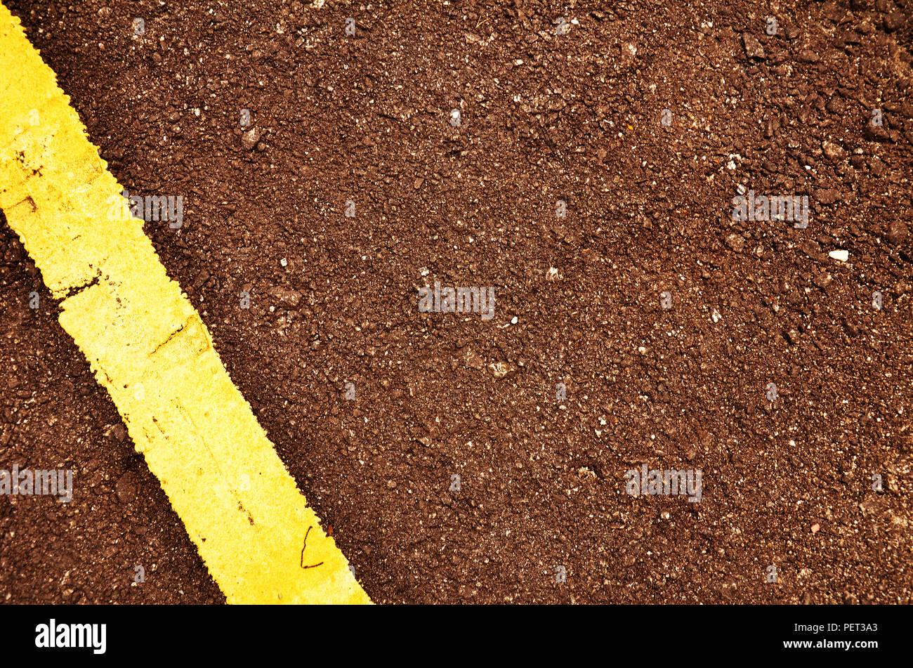 Black road pavement with single yellow line Stock Photo - Alamy