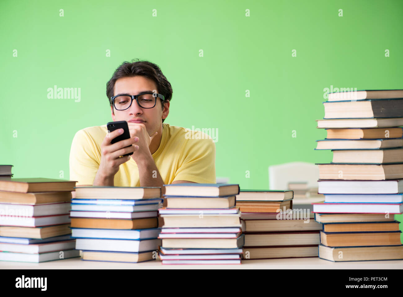 Student with too many books to read before exam Stock Photo - Alamy