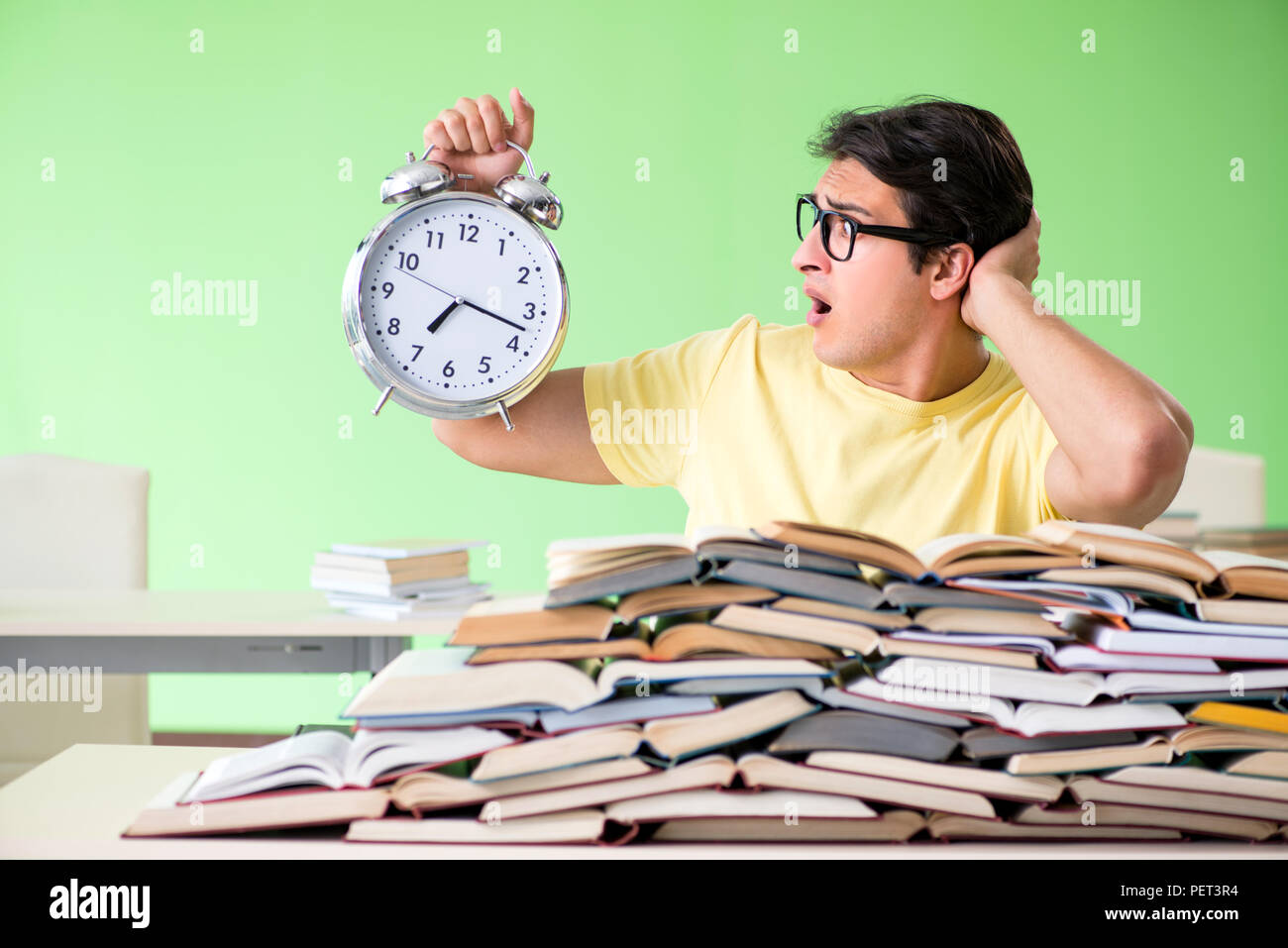Student with too many books to read before exam Stock Photo - Alamy