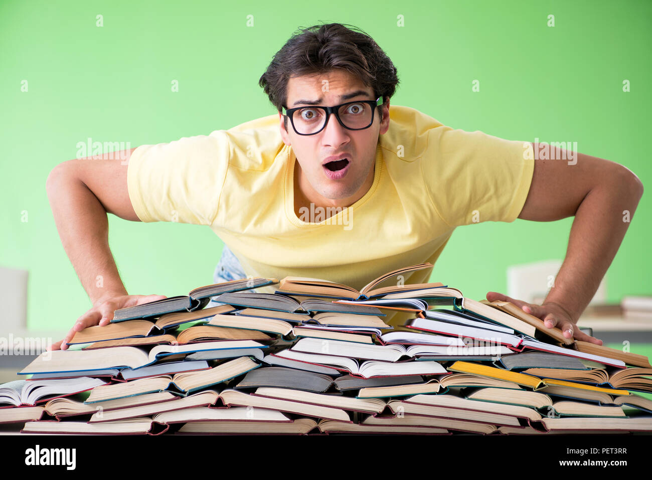 Student with too many books to read before exam Stock Photo - Alamy
