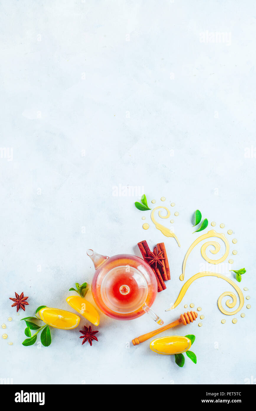 Honey and tea header. Glass teapot with decorative honey swirls, lemon ...