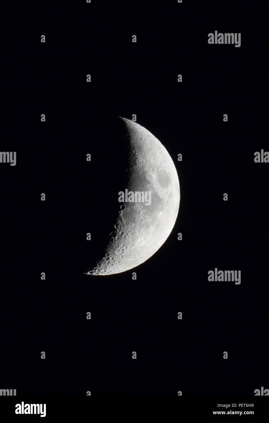 waxing crescent moon in a black night sky Stock Photo - Alamy