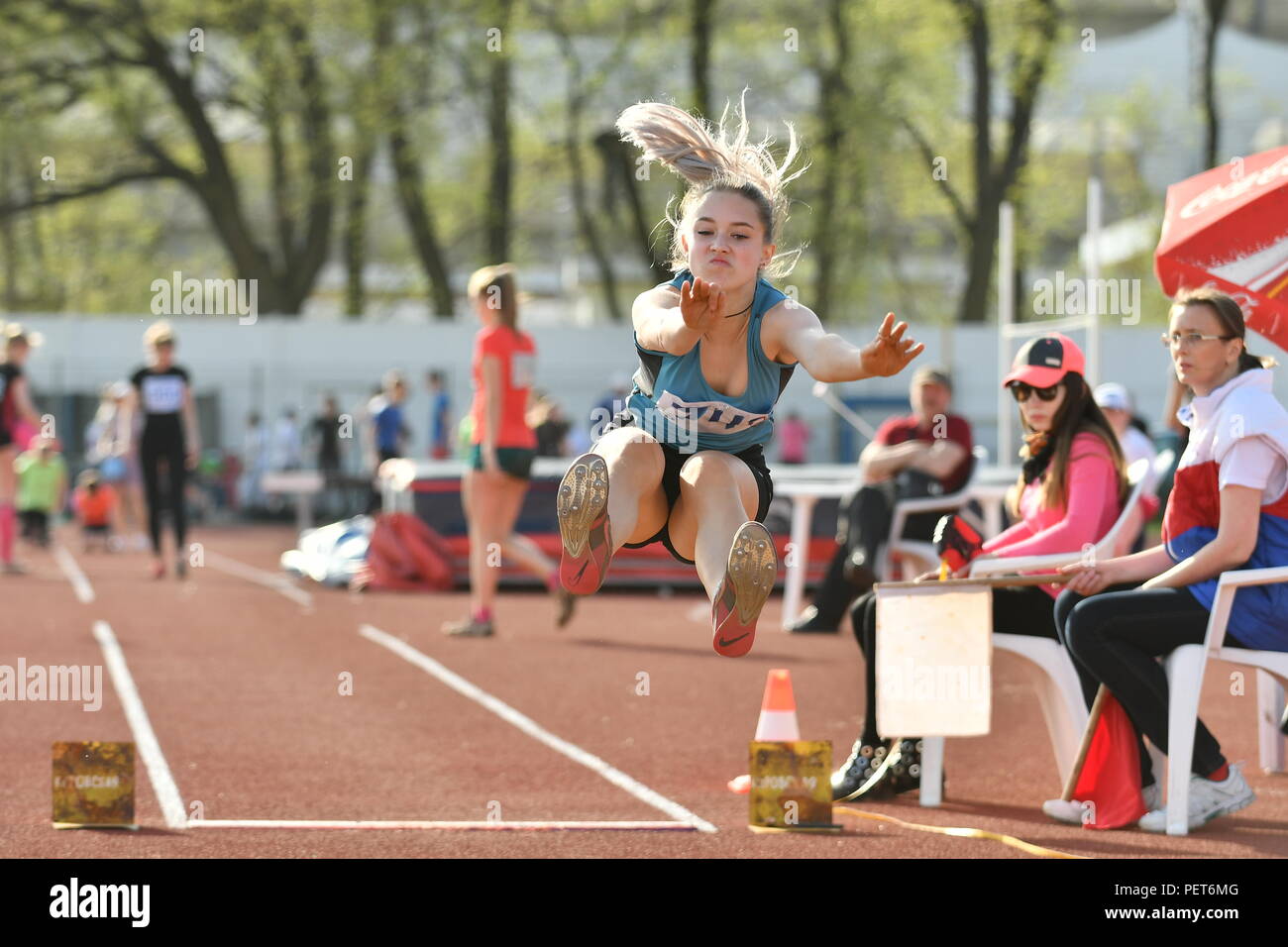 Young girl performs a long jump attempt in local competitions Stock ...