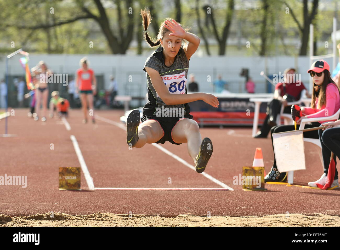 Young girl performs a long jump attempt in local competitions Stock ...