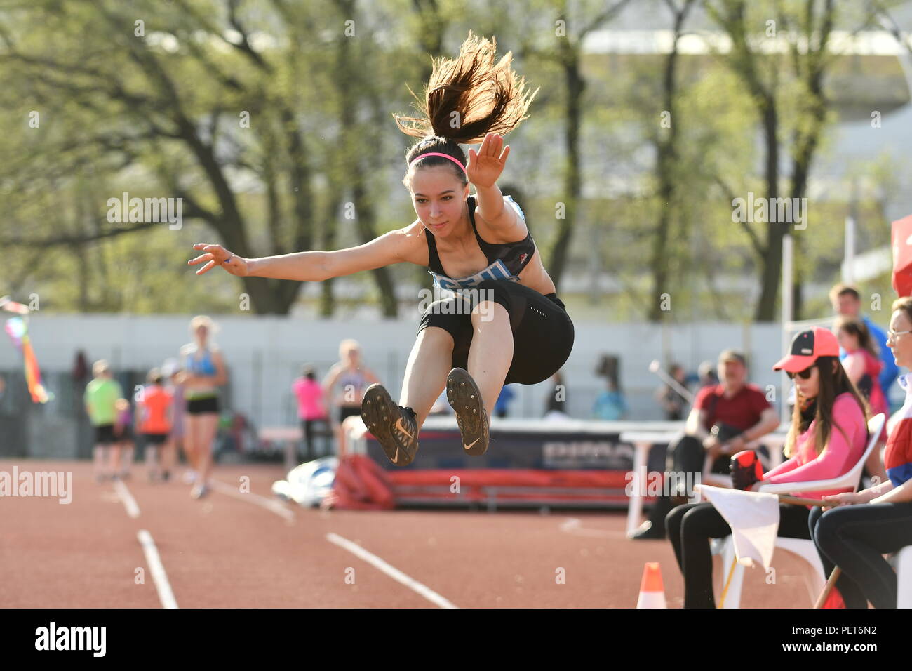Young girl performs a long jump attempt in local competitions Stock ...