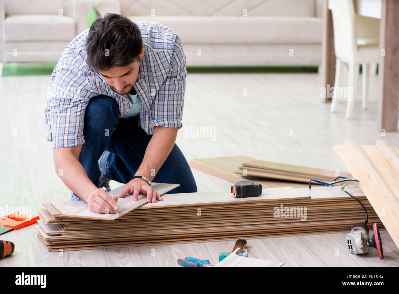 Man laying flooring at home Stock Photo - Alamy
