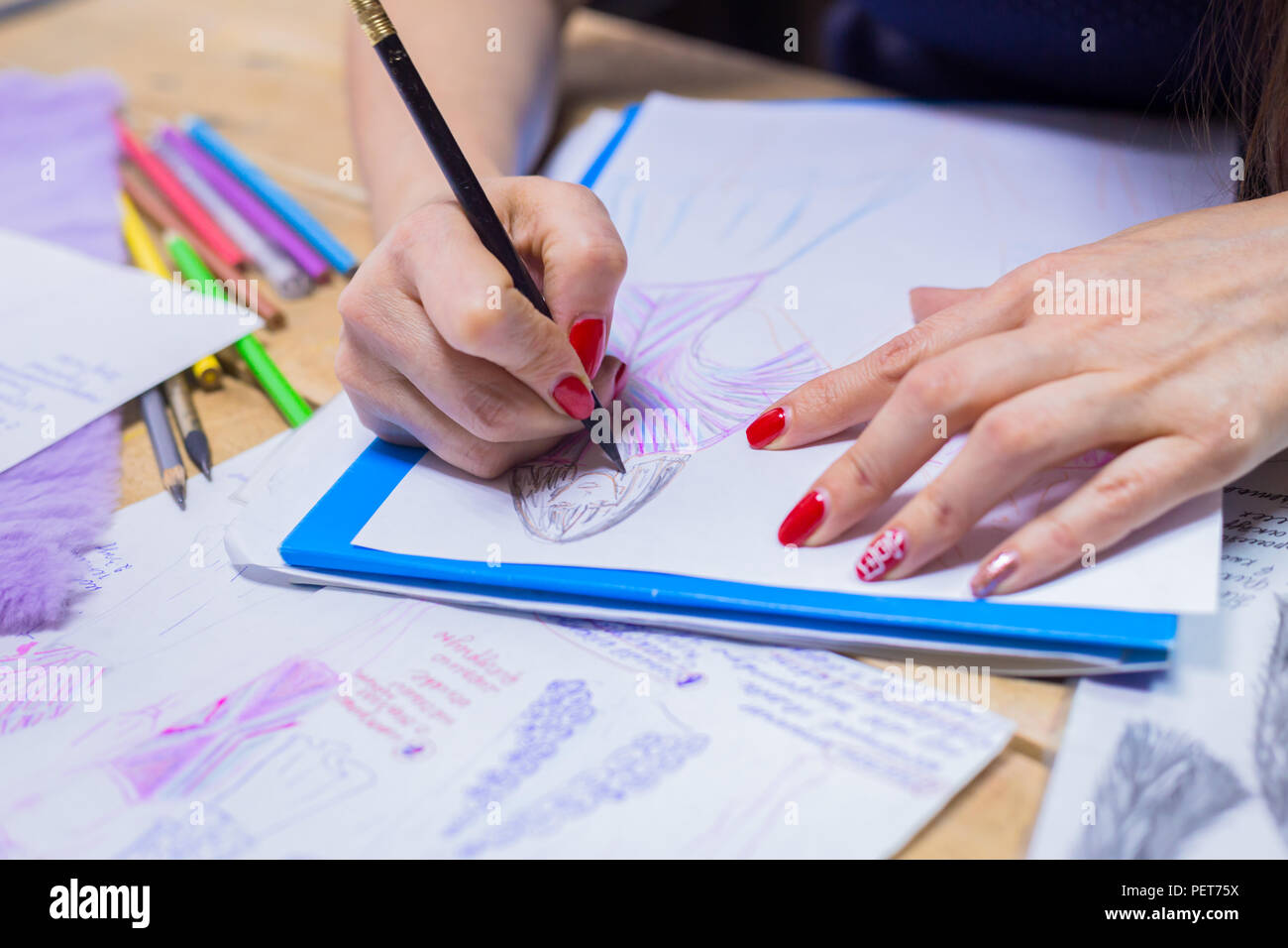 Close up shot - hands of professional tailor, designer drawing fashion ...