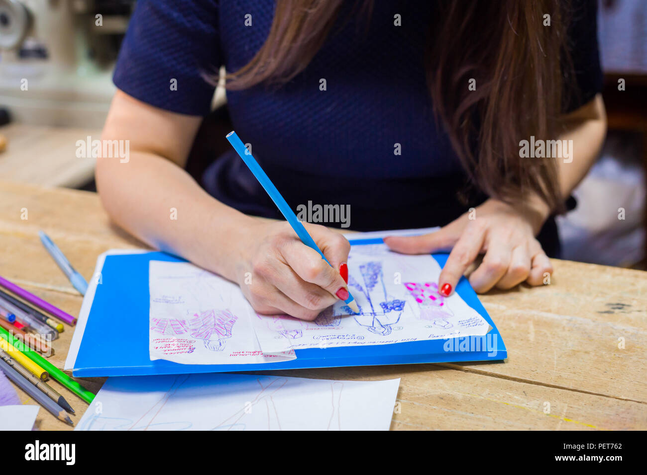 Close up shot - hands of professional tailor, designer drawing fashion ...