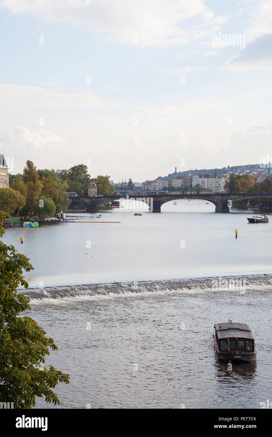 Beautiful Prague City View along the river with tourist boat Stock ...
