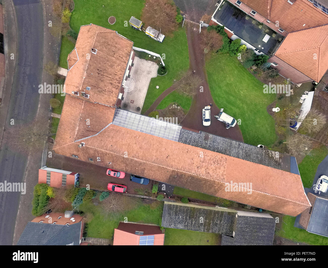 Aerial view of a barn, a house and a lawn with a vertical downward view ...