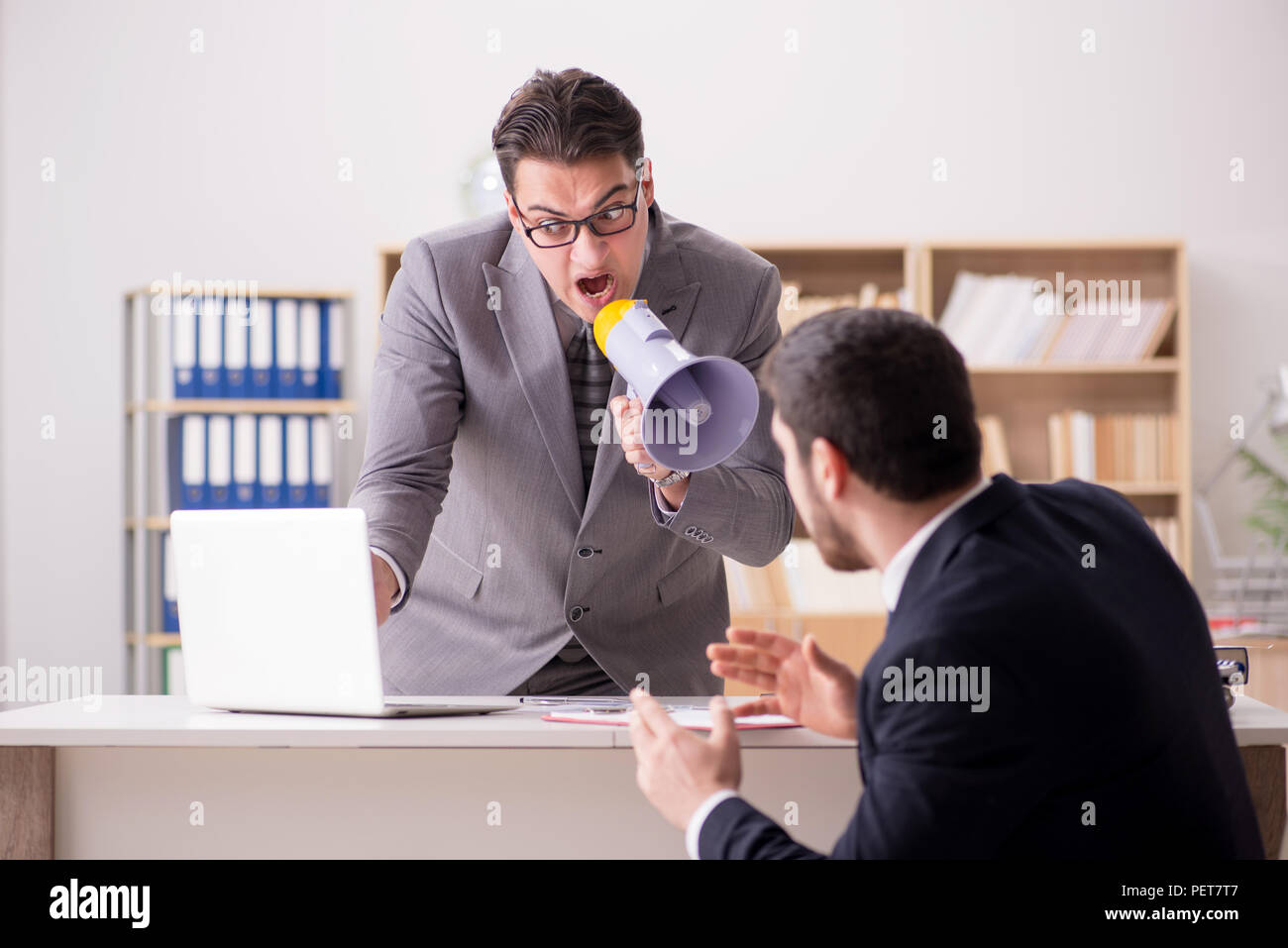 Angry boss shouting at his employee Stock Photo - Alamy