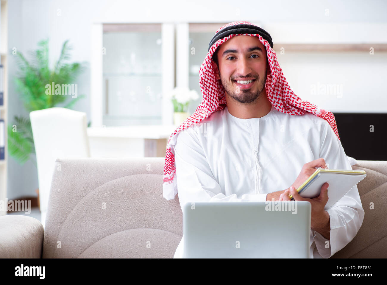 Arab man working at home on his work Stock Photo - Alamy