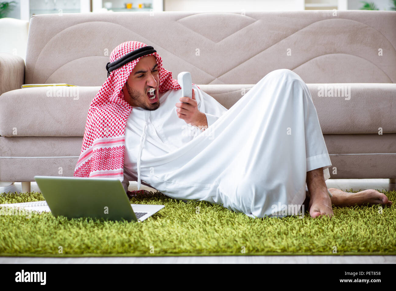 Arab man working at home on his work Stock Photo - Alamy