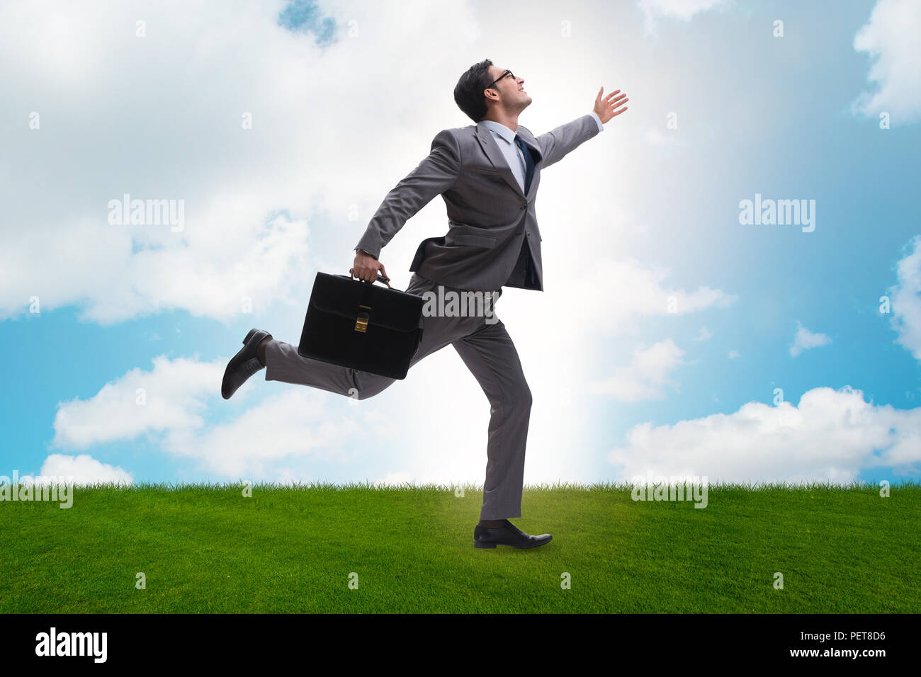 Happy businessman running towards his goal Stock Photo - Alamy