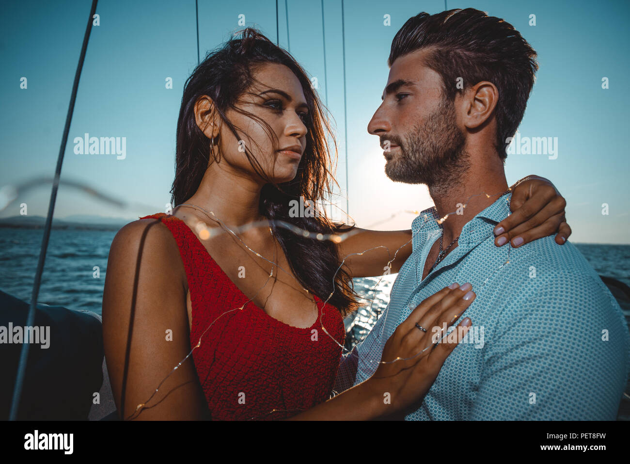 happy couple taking a romantic cruise on the sail boat Stock Photo - Alamy