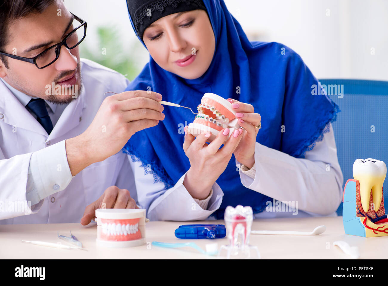 Dentist doctor and assistant working on new tooth implant Stock Photo ...