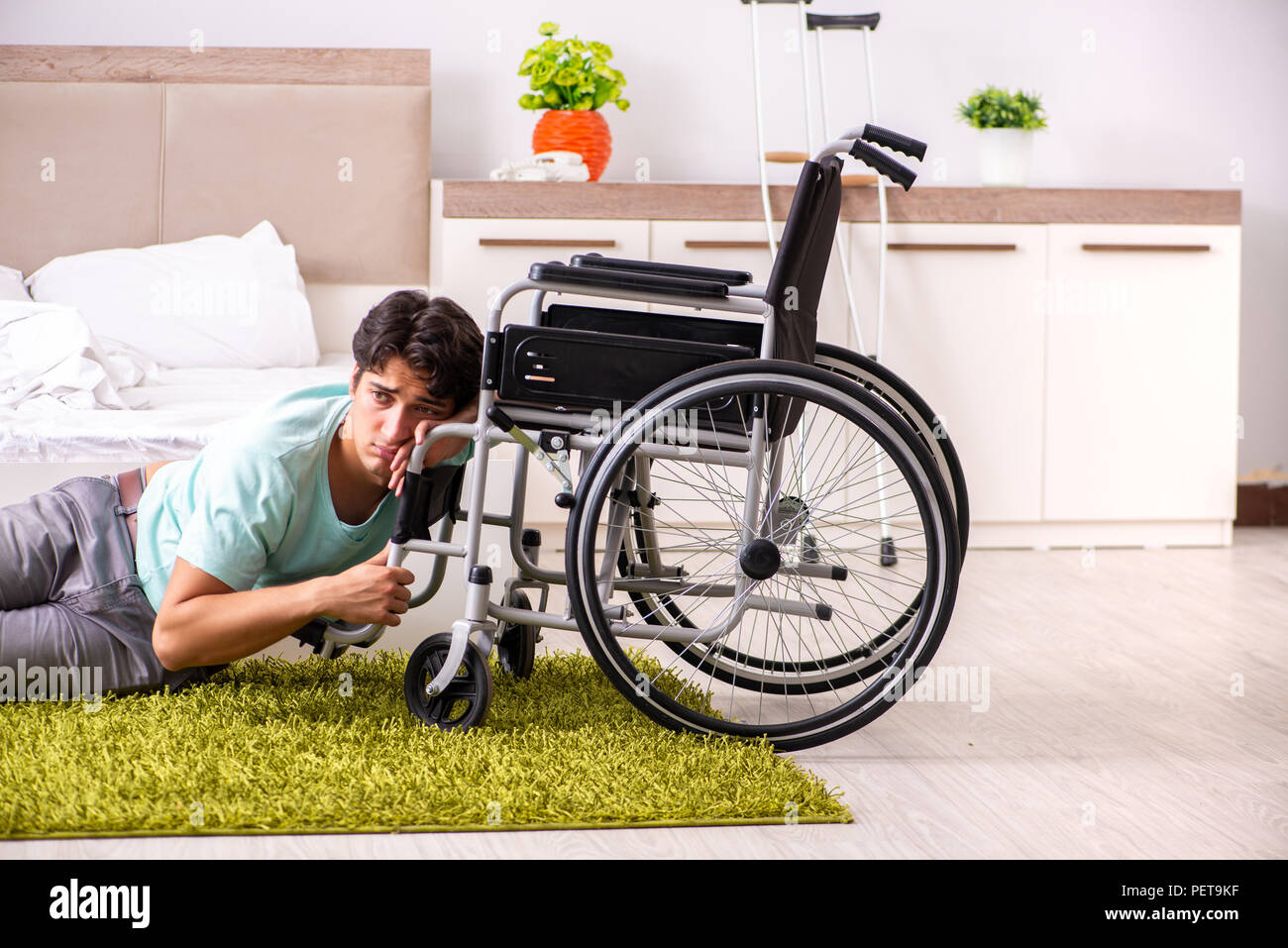 Young handsome disabled man recovering at home Stock Photo - Alamy