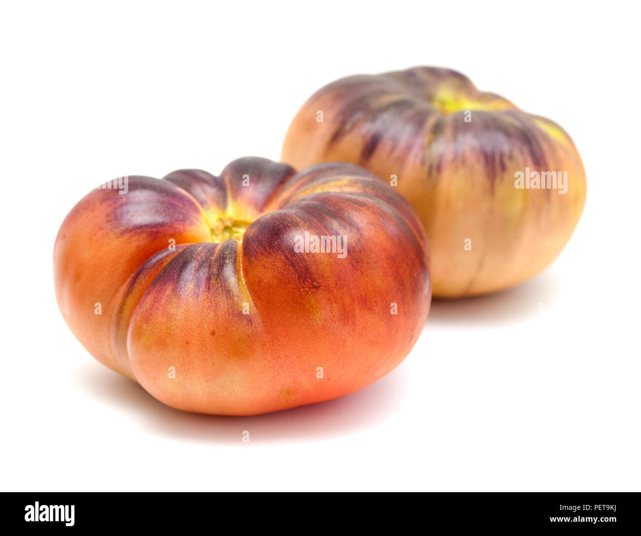 large unripe blue tomatoes isolated on white background Stock Photo - Alamy