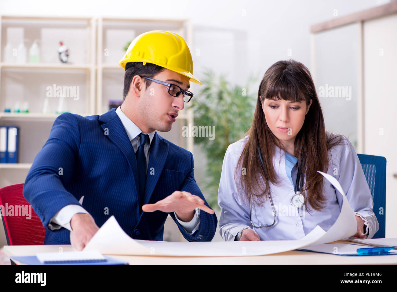 Doctor discussing new hospital plan with architect Stock Photo - Alamy