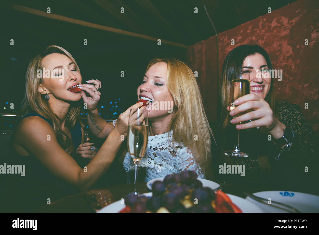 Party girls in a restaurant celebrating with drinks and champagne Stock ...