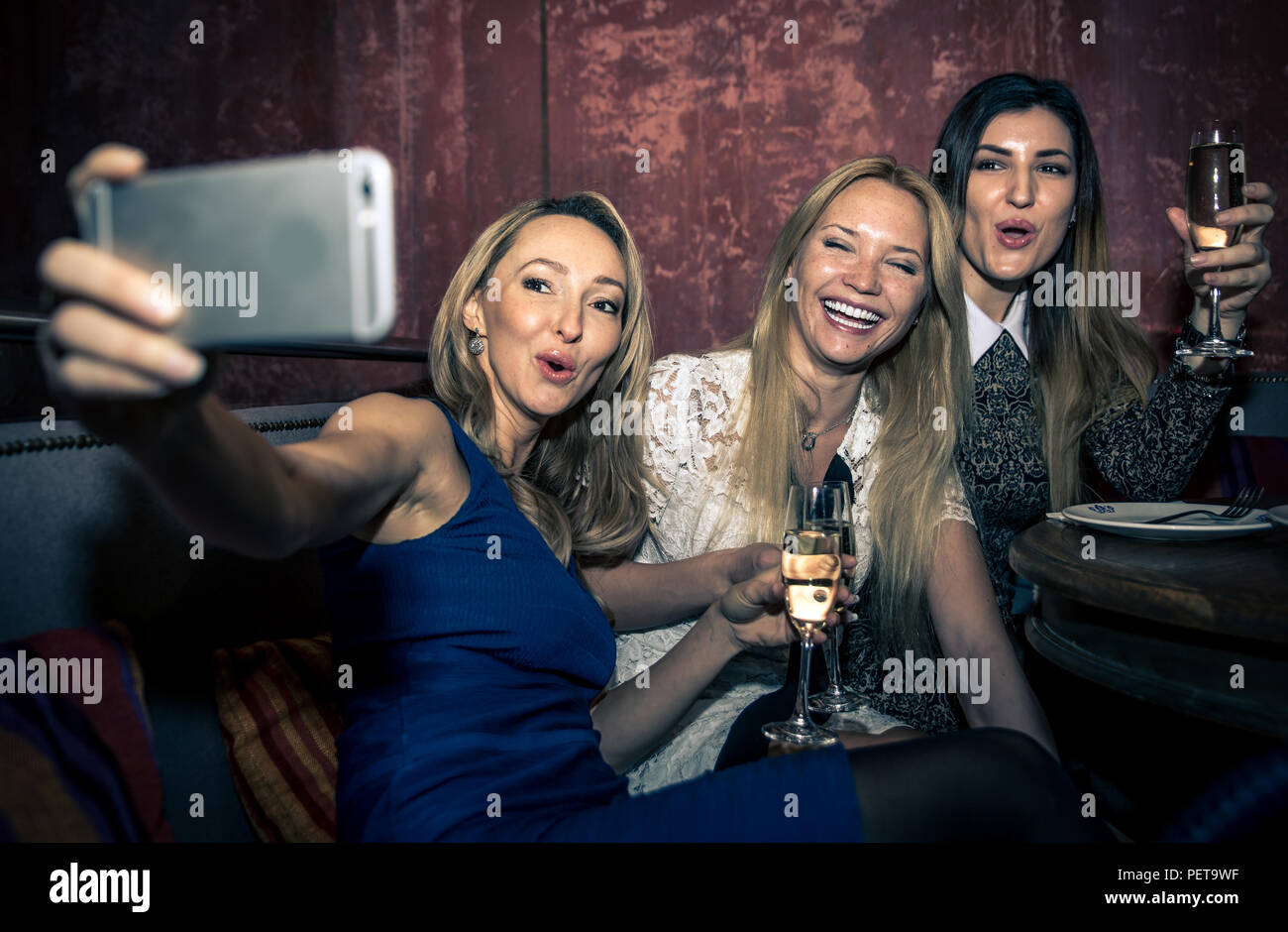 Party girls in a restaurant celebrating with drinks and champagne Stock ...