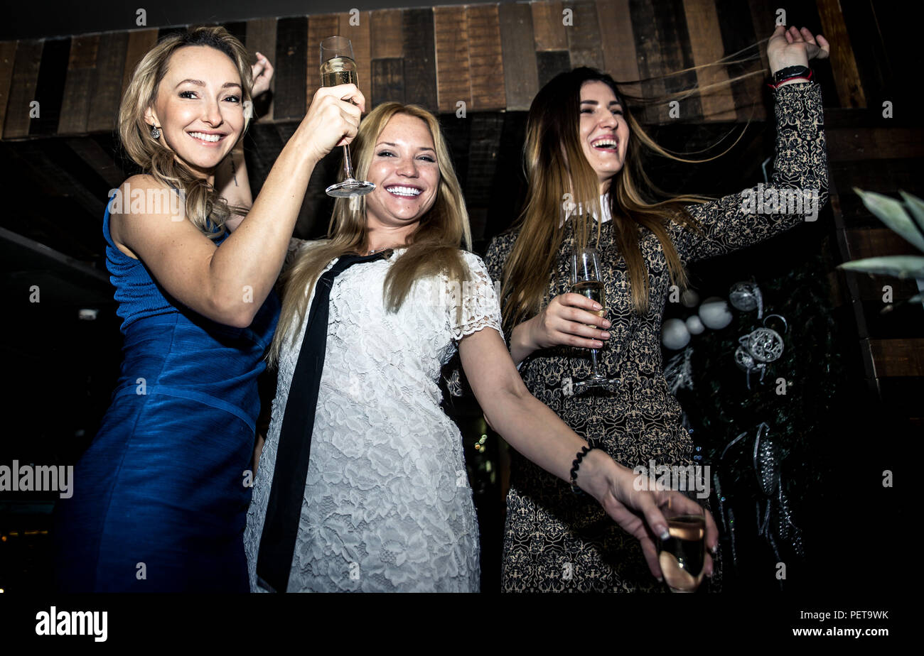 Party girls in a restaurant celebrating with drinks and champagne Stock ...