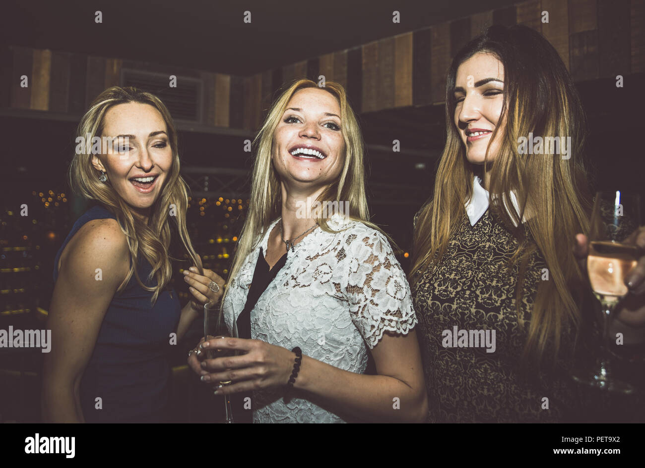 Party girls in a restaurant celebrating with drinks and champagne Stock ...