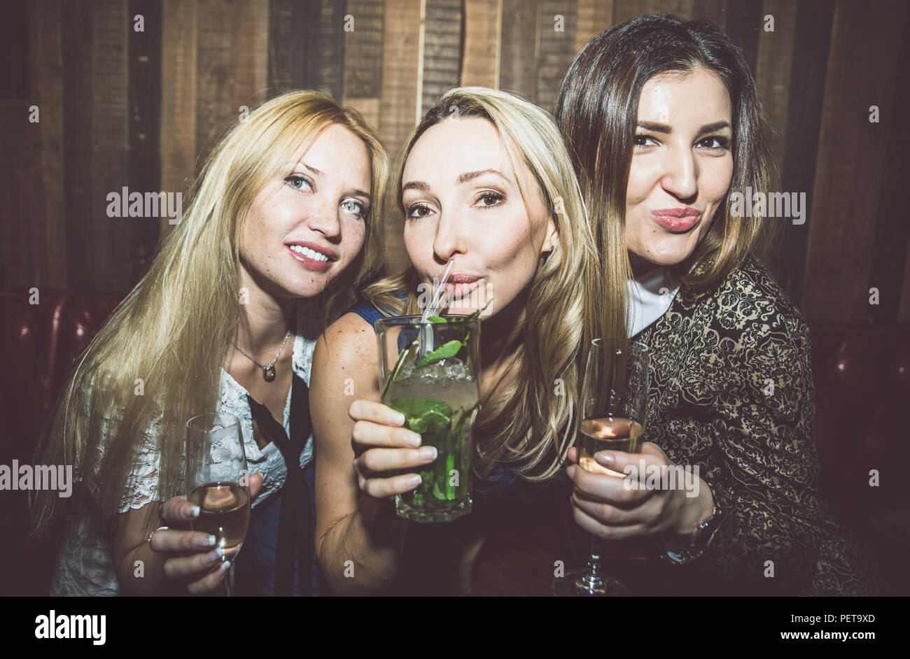 Party girls in a restaurant celebrating with drinks and champagne Stock ...