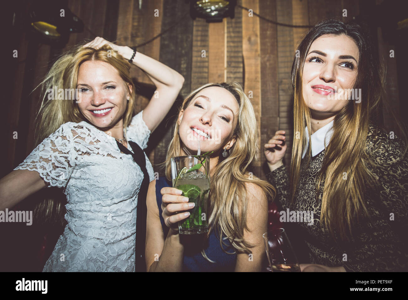 Party girls in a restaurant celebrating with drinks and champagne Stock ...