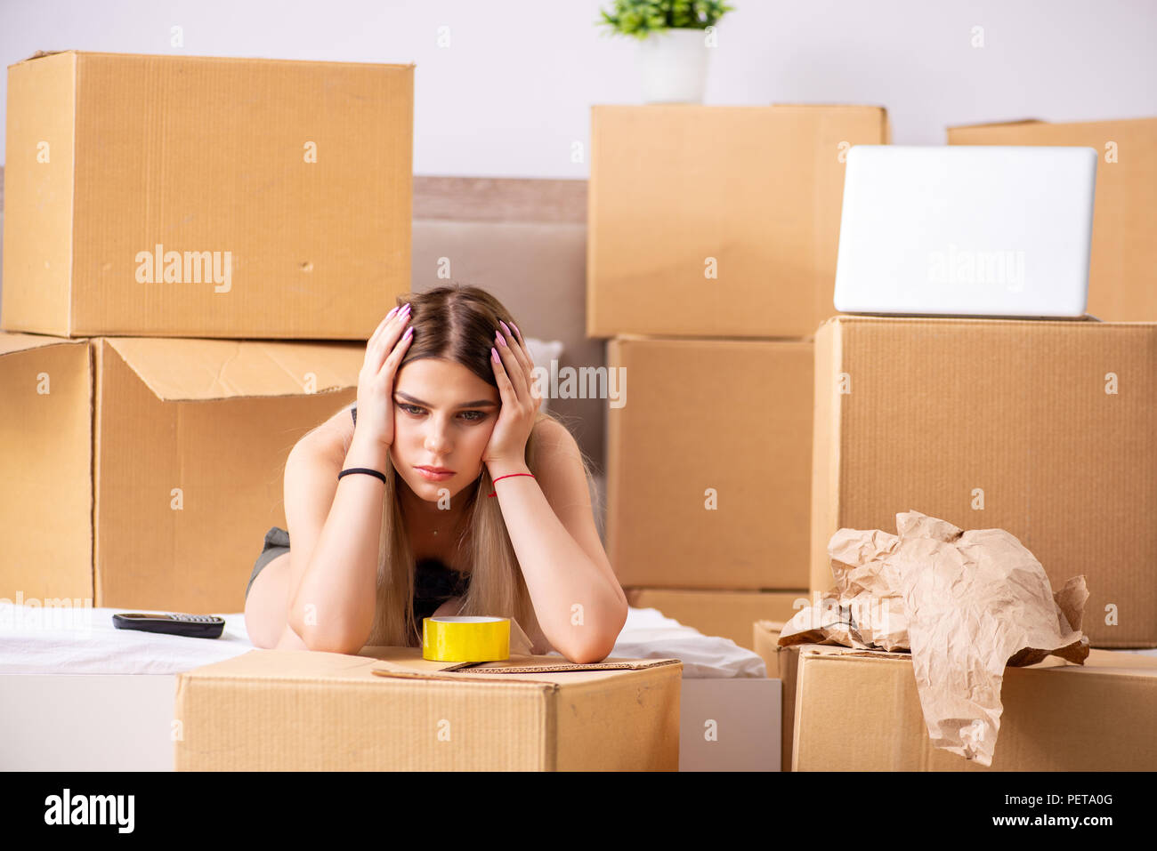 Young woman moving to new place Stock Photo - Alamy