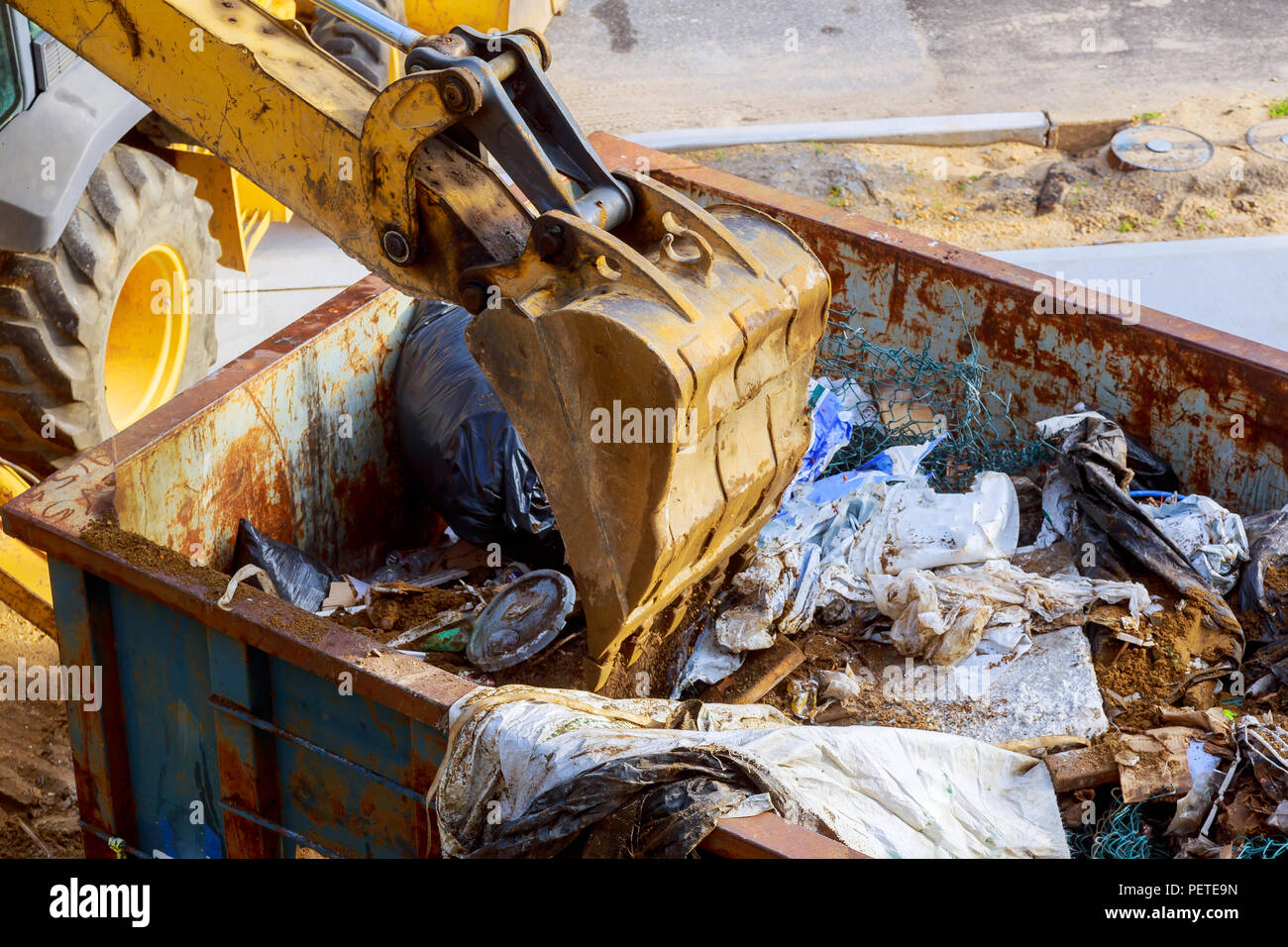 wheel material handler dumping refuse disposal with excavator shovel ...