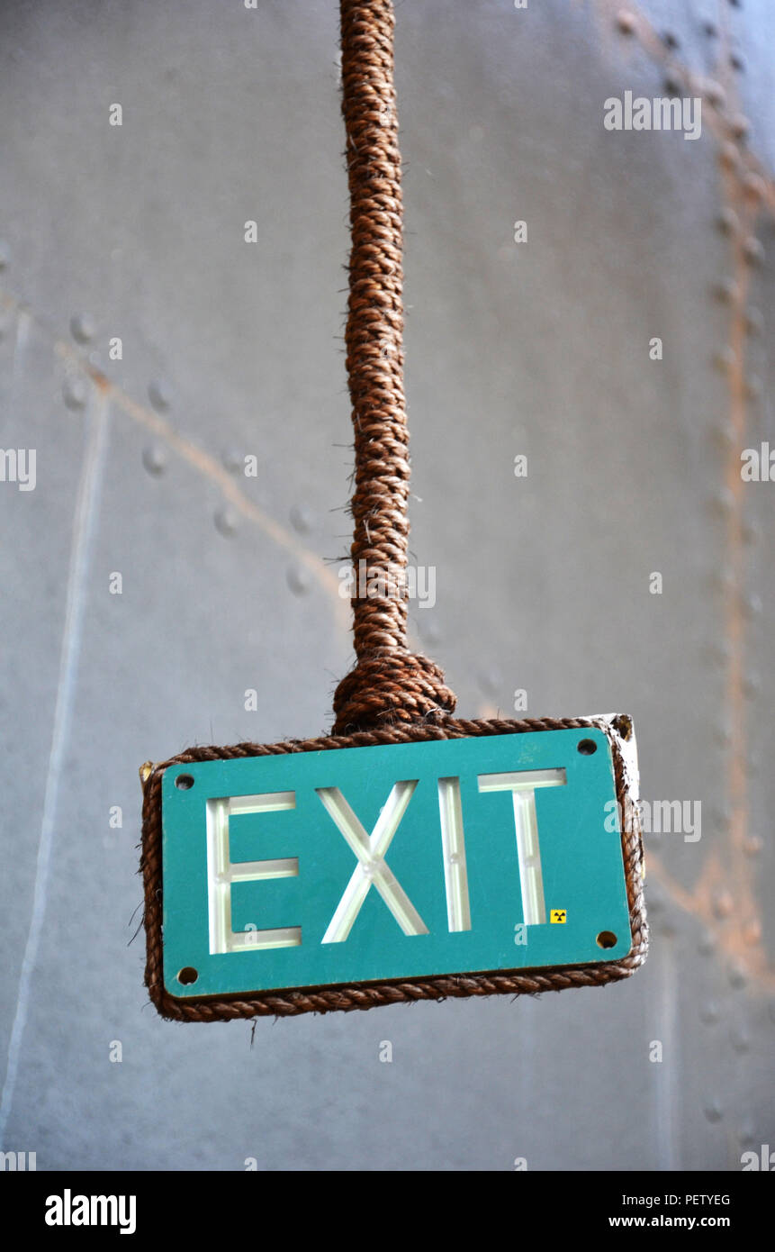 Exit sign points the way out of building Stock Photo - Alamy