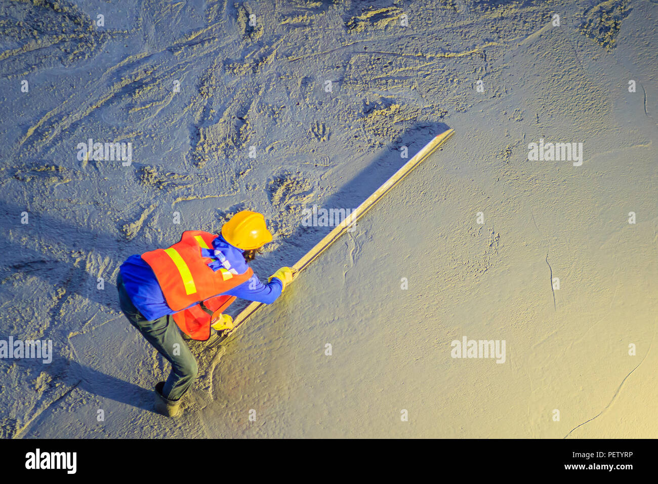 Mason worker leveling concrete with trowels, mason hands spreading ...